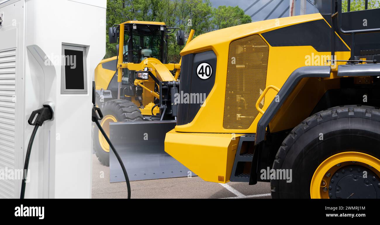 Electric construction machines with charging station. Concept Stock ...