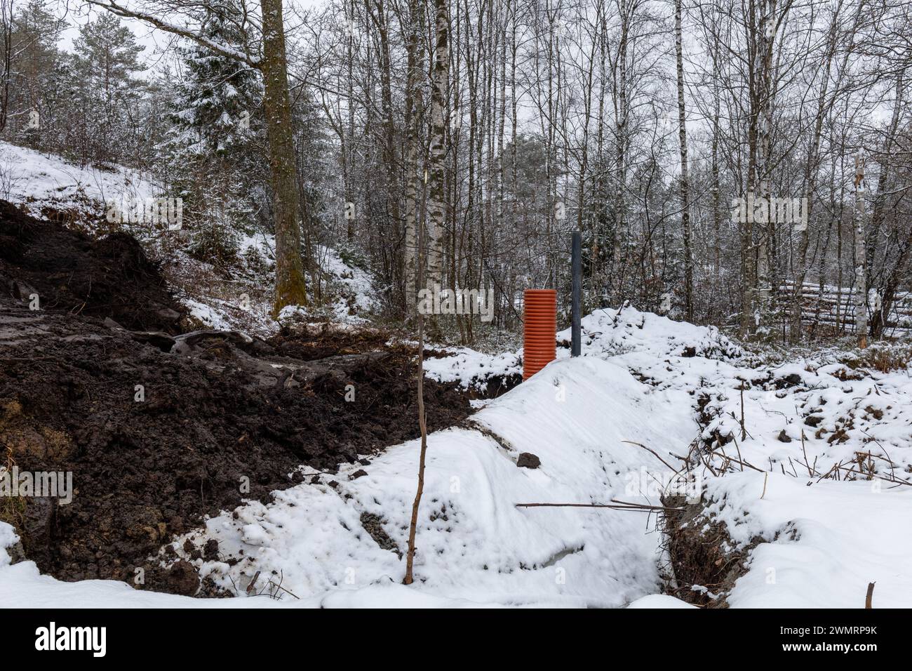 Trench with ventilation piping for home sewage under construction in ...