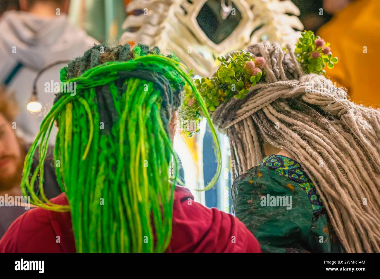 Back view of two girls with dreadlocks and clover wreaths on their ...