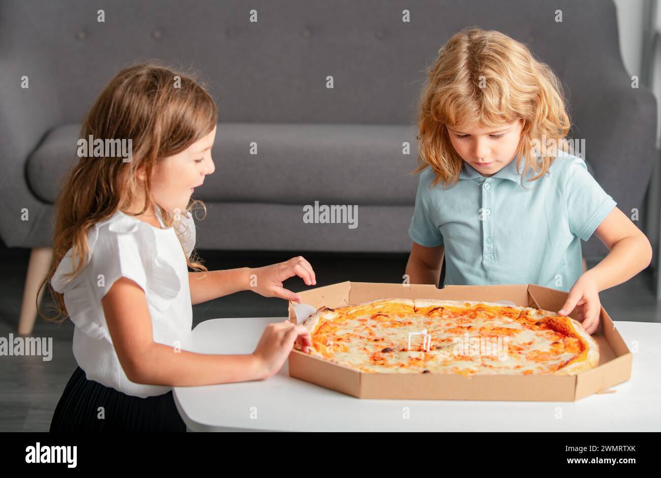 Hungry children eating pizza. Kids preparing to eat fresh pizza Stock ...