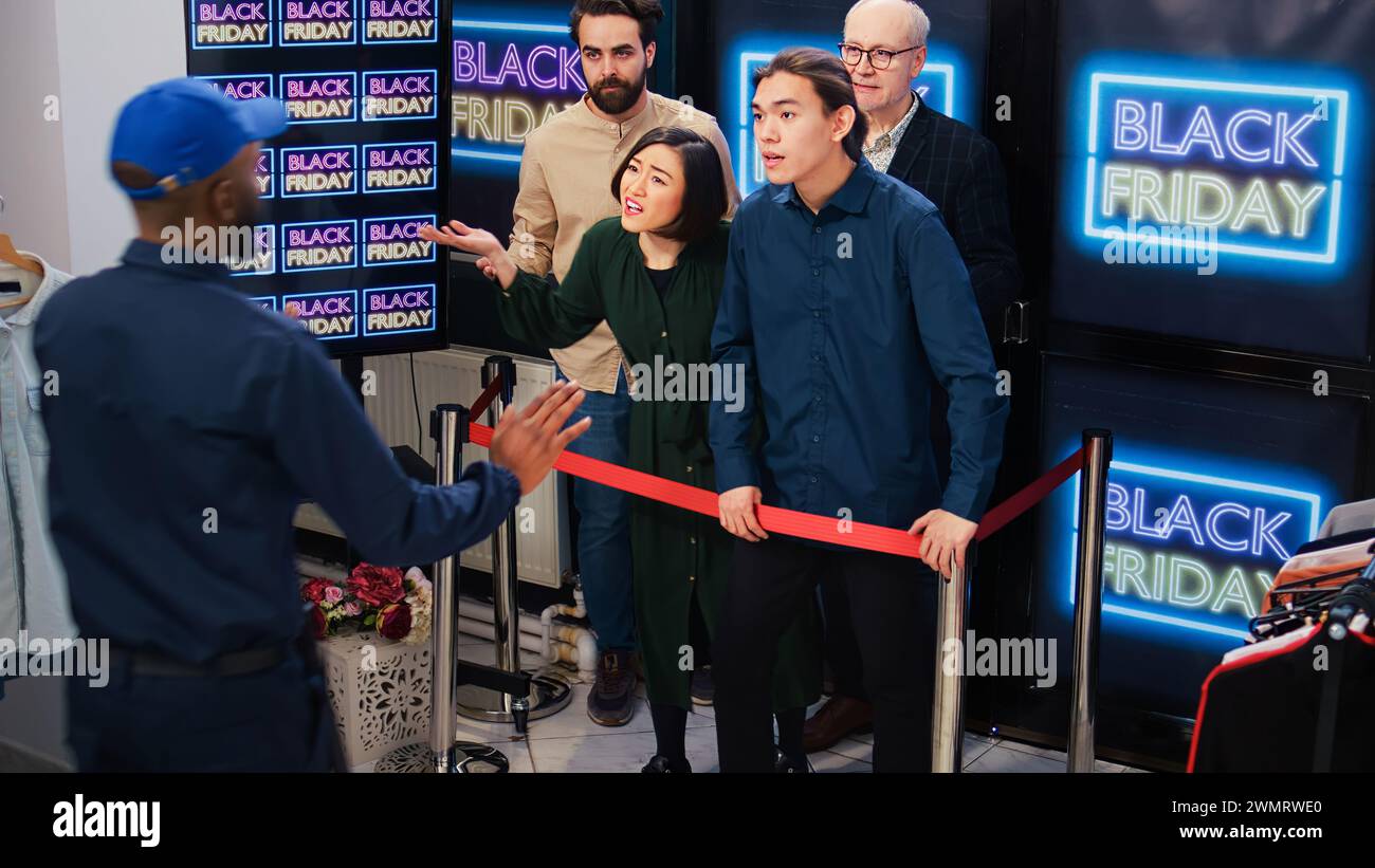 Crazy clients pushing man on floor during black friday sales, crowd of ...