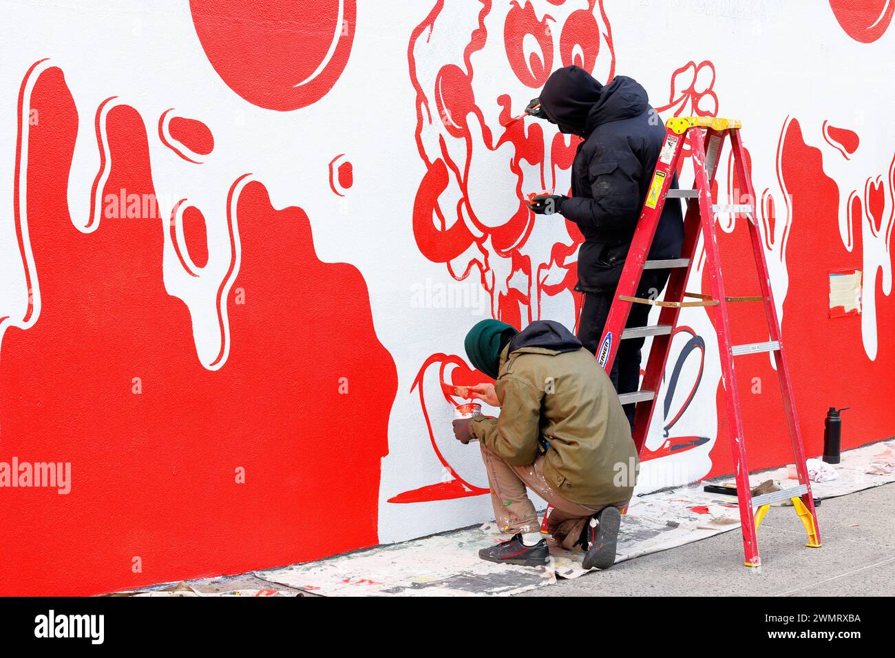 Commercial artists hand painting an advertisement on a wall in New York ...