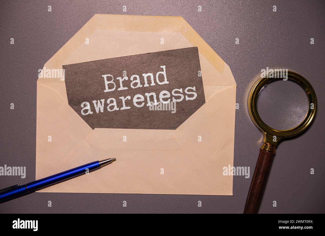 Businessman shows a banner with the message brand awareness. Business ...