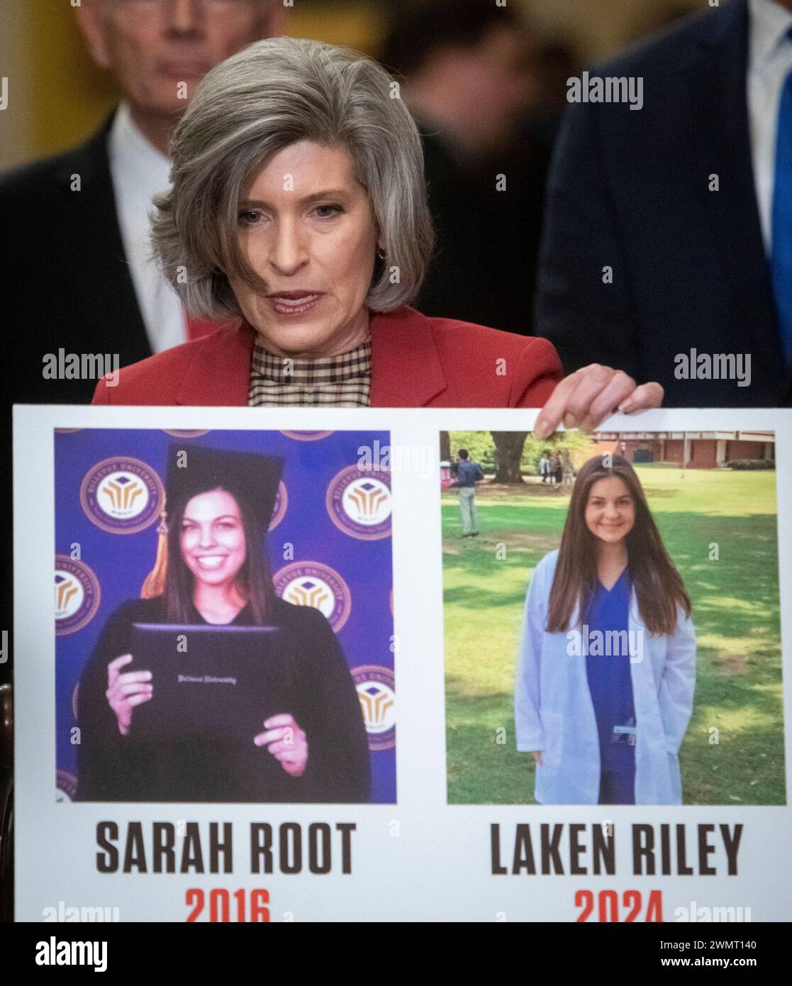 United States Senator Joni Ernst (Republican of Iowa) holds a poster ...