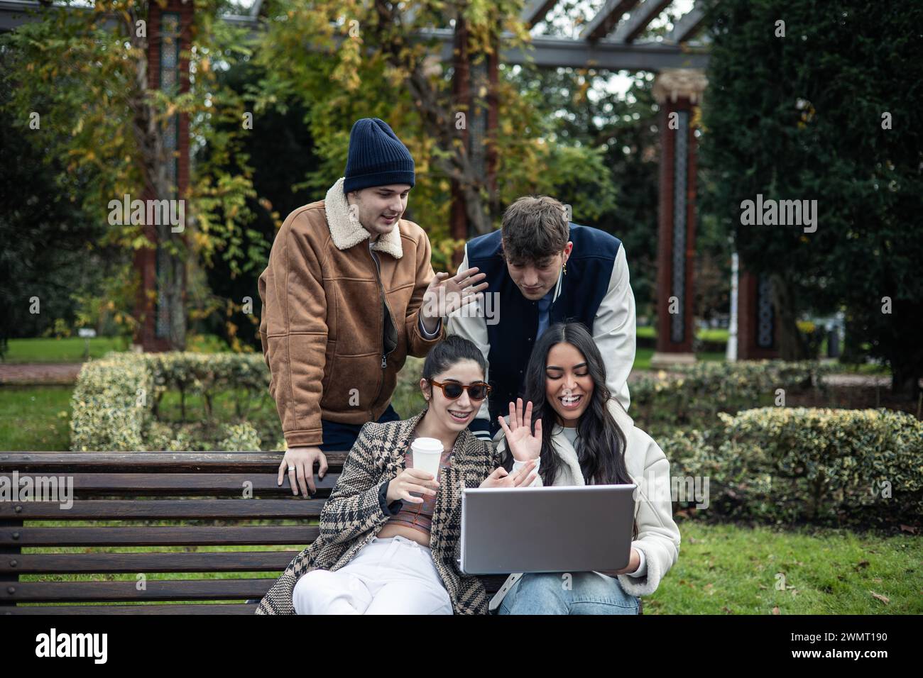 four friends two latina girls and doc caucasian guys waving at the ...