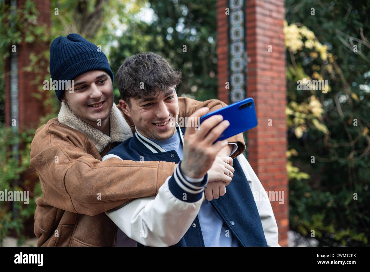 couple boyfriends young students taking a selfie with smartphone ...