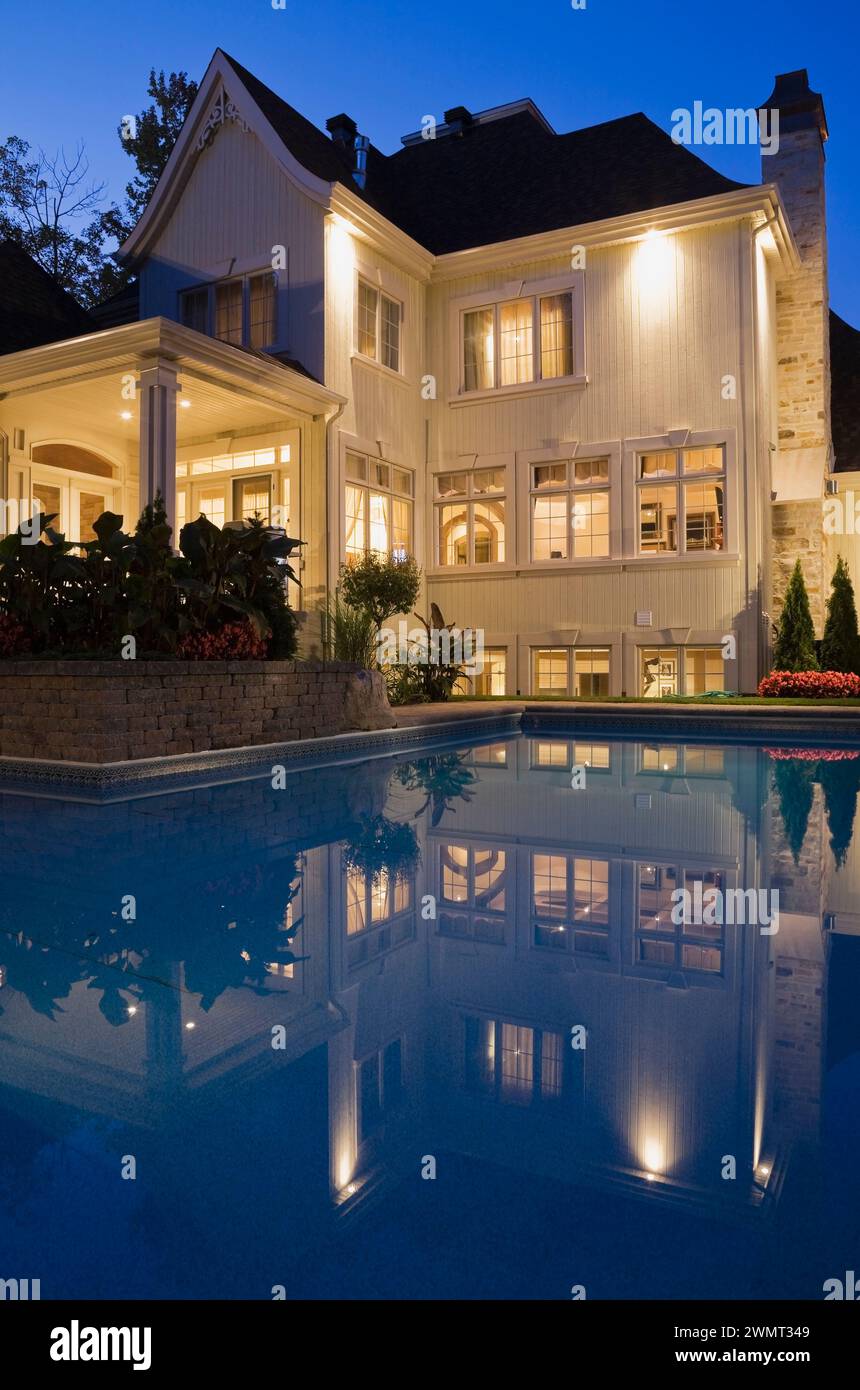 L-shaped in-ground swimming pool in backyard of luxurious two story ...