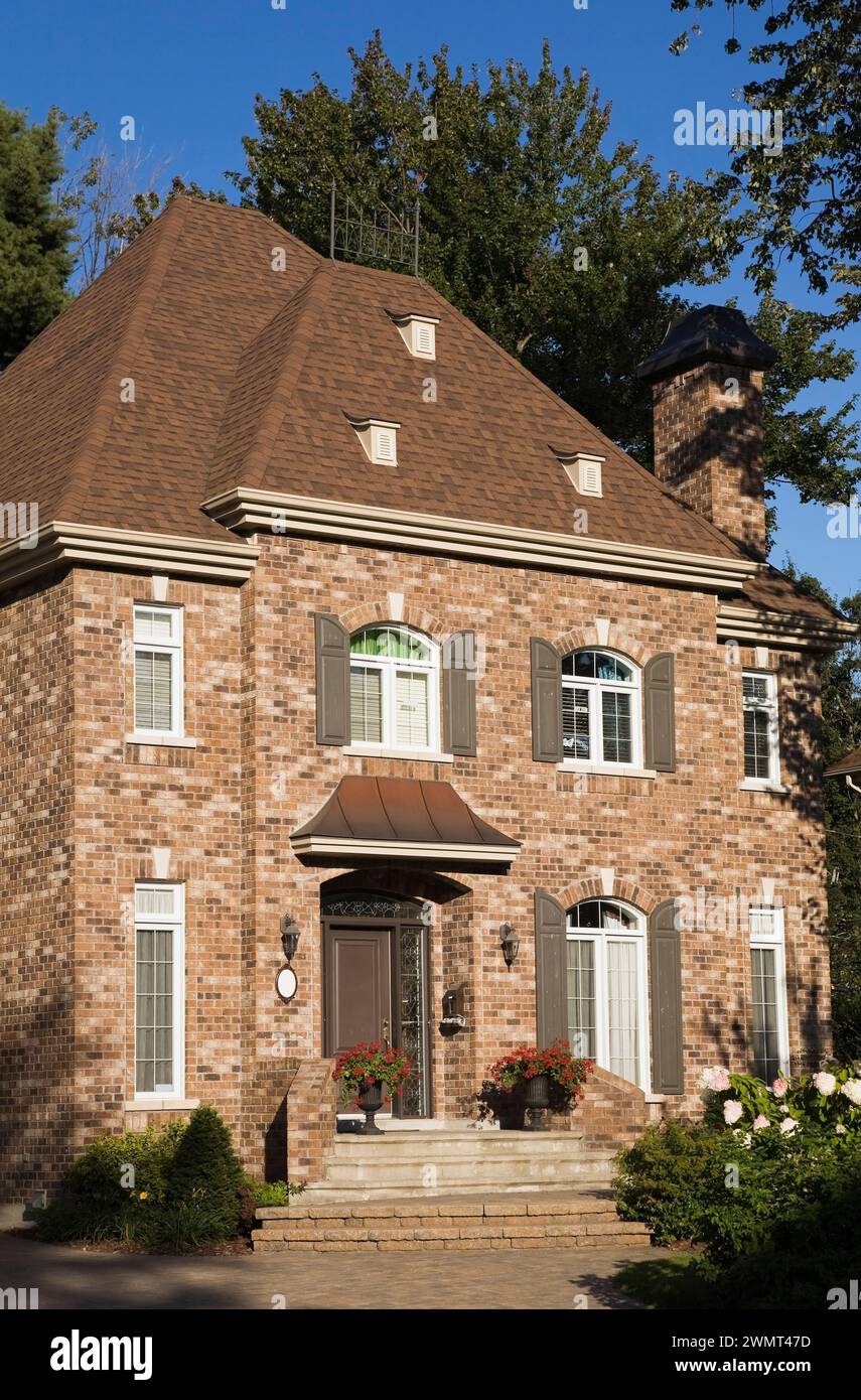 Luxurious two story nuanced tan and brown brick French Manor style home ...