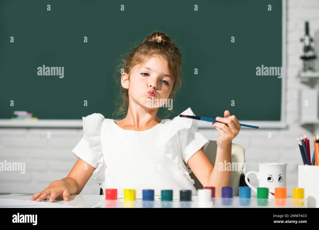 Cute little girl child painting with paints color and brush. Little ...