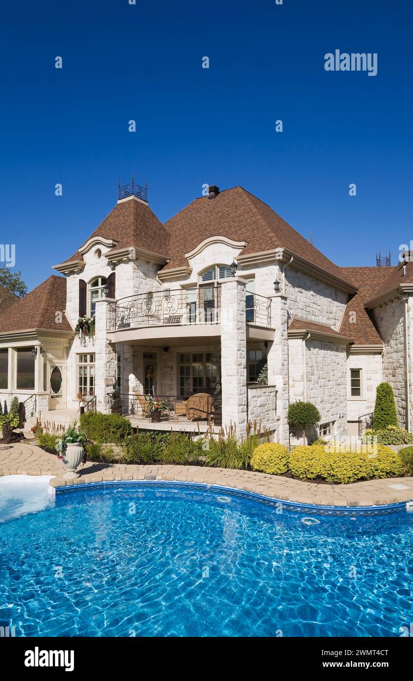 In-ground swimming pool in backyard of luxurious two story light ...