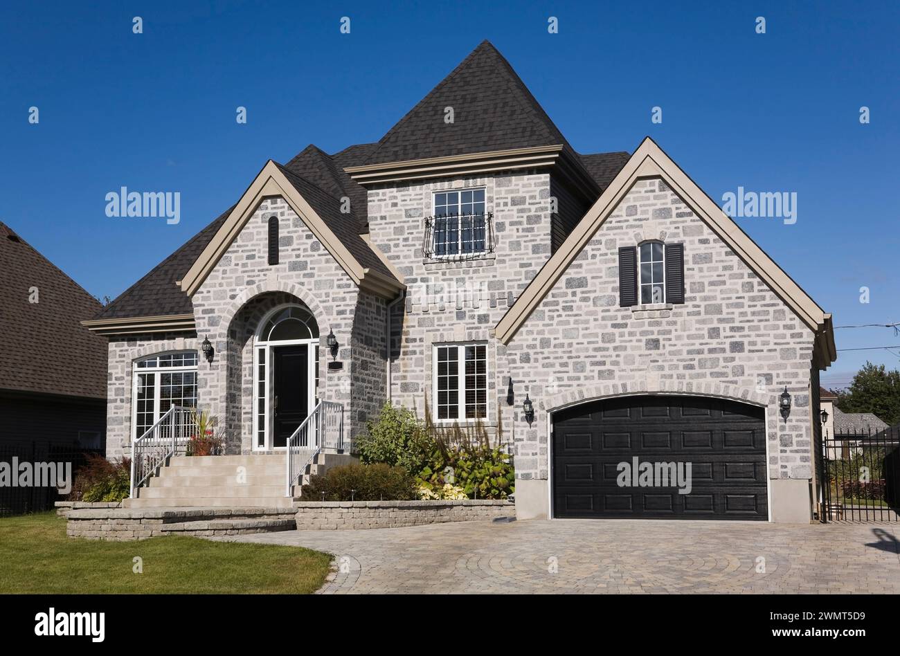 Contemporary two story nuanced grey cut stone home with one car garage ...