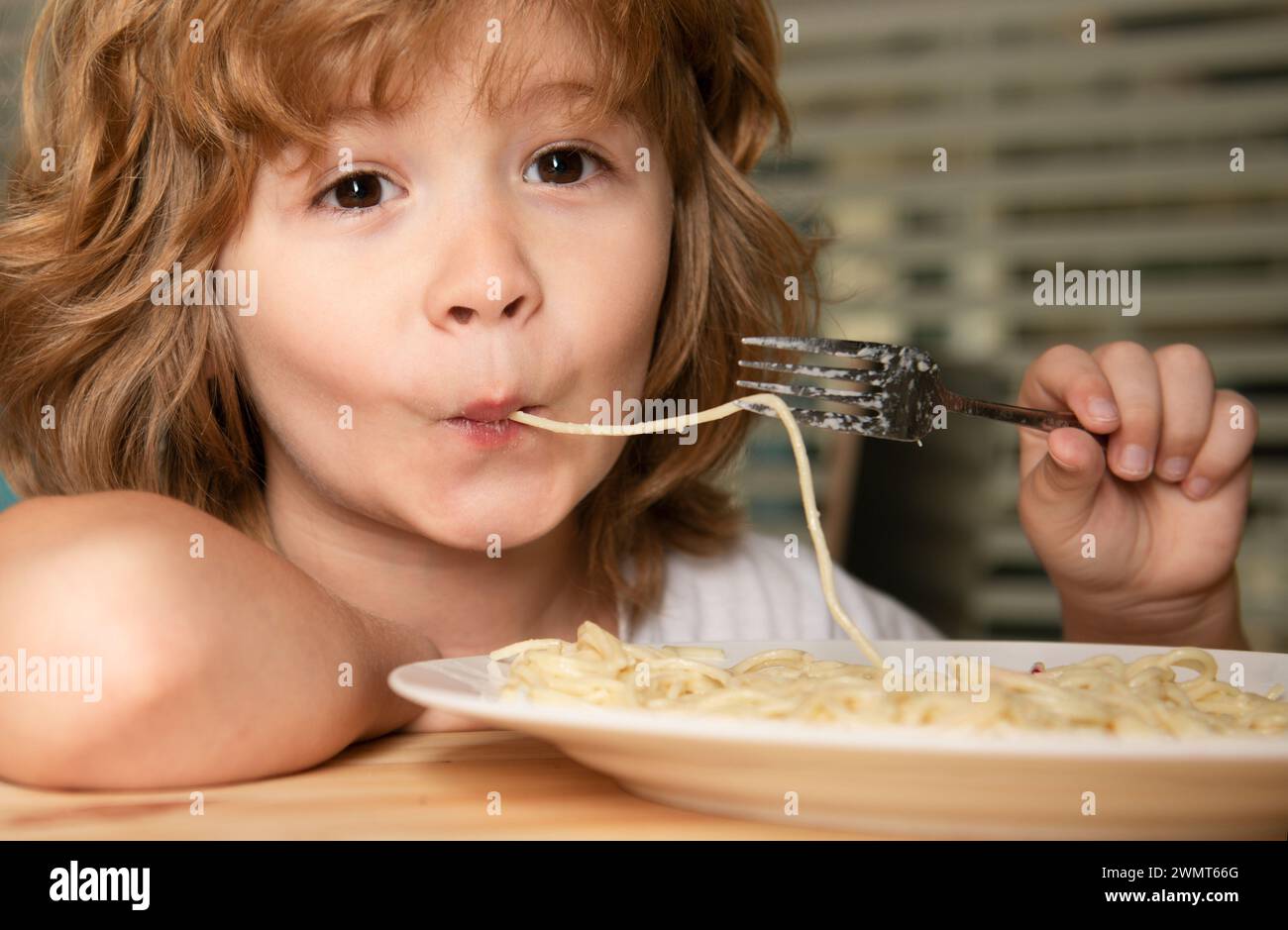 Kids eating pasta, spaghetti, close up cute funny child Stock Photo - Alamy