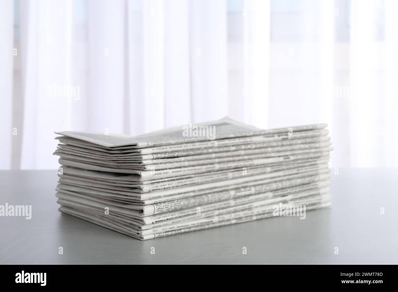 Stack of newspapers on light grey table. Journalist's work Stock Photo ...
