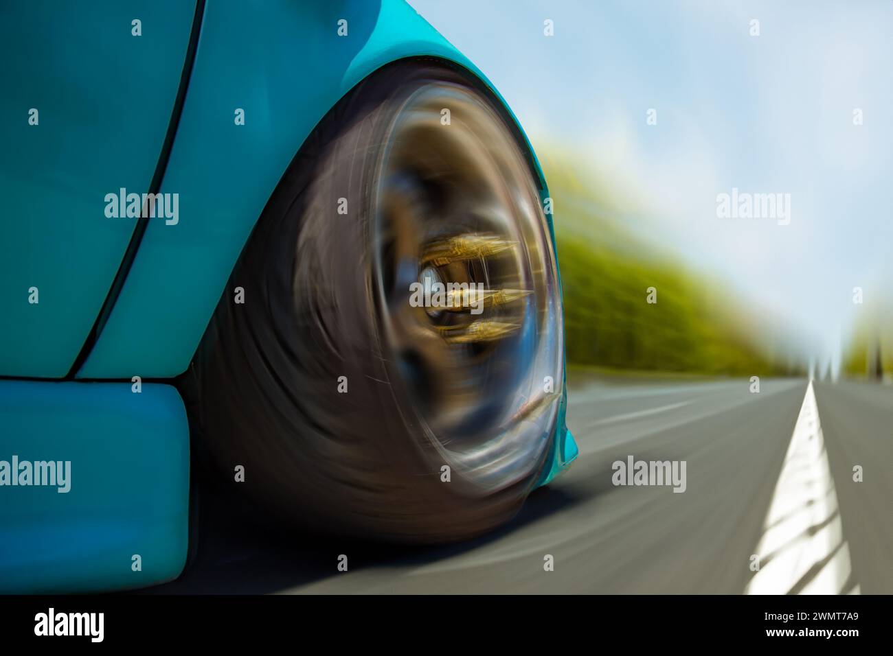 The front wheel of a tuning car driving fast on the road Stock Photo ...