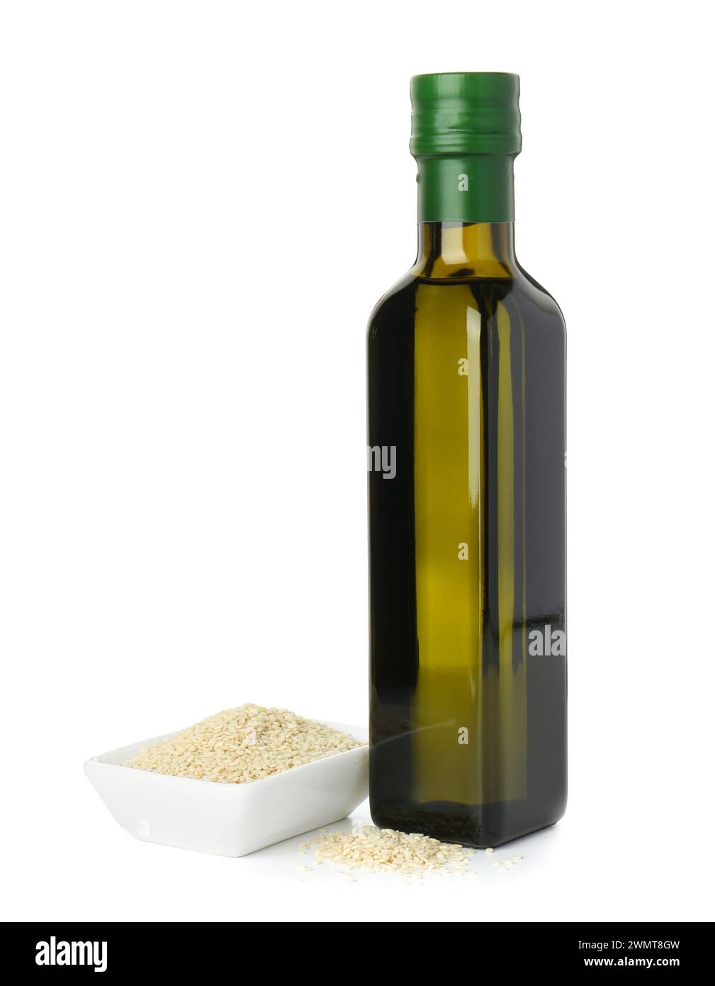 Vegetable fats. Sesame oil in glass bottle and seeds isolated on white ...