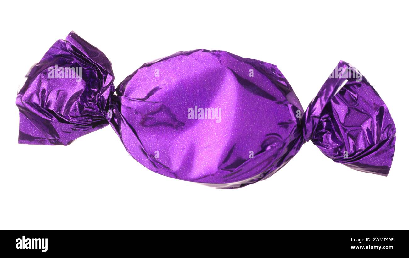 Candy in purple wrapper isolated on white Stock Photo - Alamy