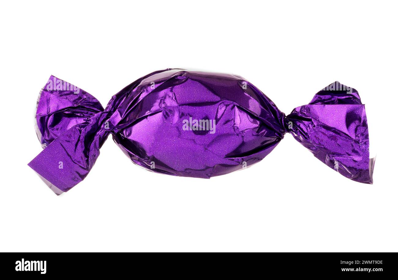 Candy in purple wrapper isolated on white Stock Photo - Alamy