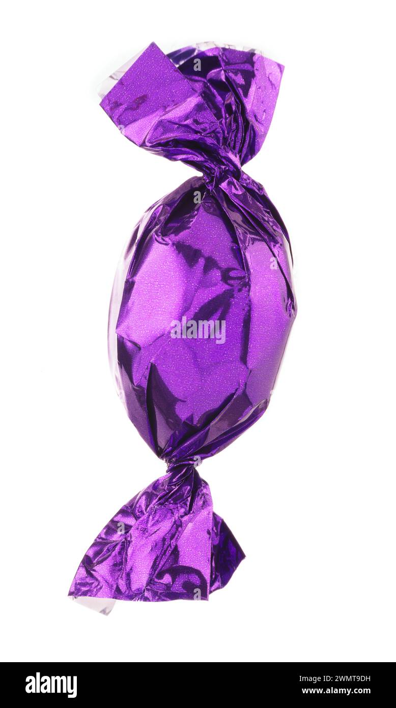 Candy in purple wrapper isolated on white Stock Photo - Alamy