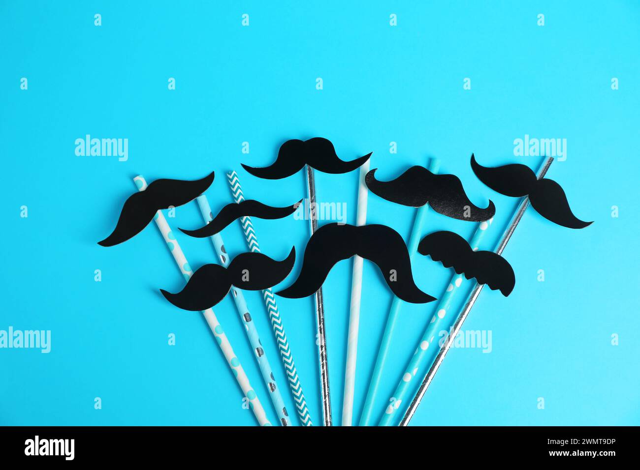 Fake paper mustaches with party props on light blue background, flat ...
