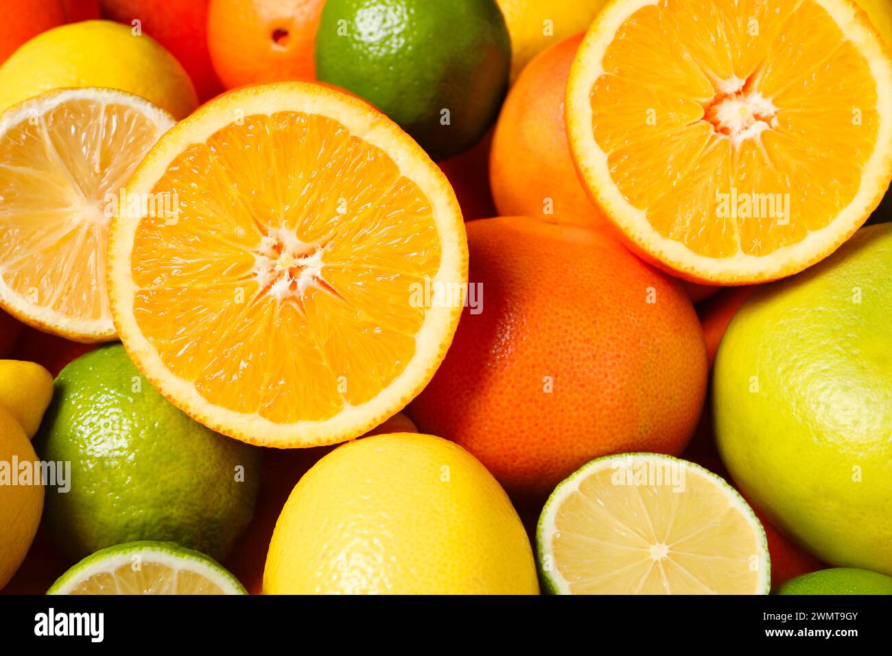 Different fresh citrus fruits as background, closeup Stock Photo - Alamy