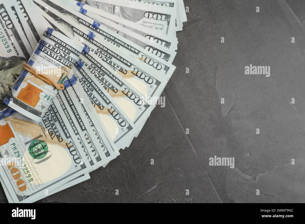 Money exchange. Dollar banknotes on dark gray textured background, top ...