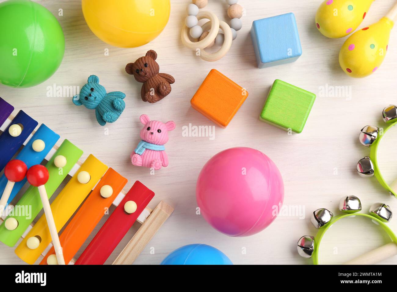 Baby song concept. Wooden tambourines , xylophone and toys on table, flat lay Stock Photo - Alamy