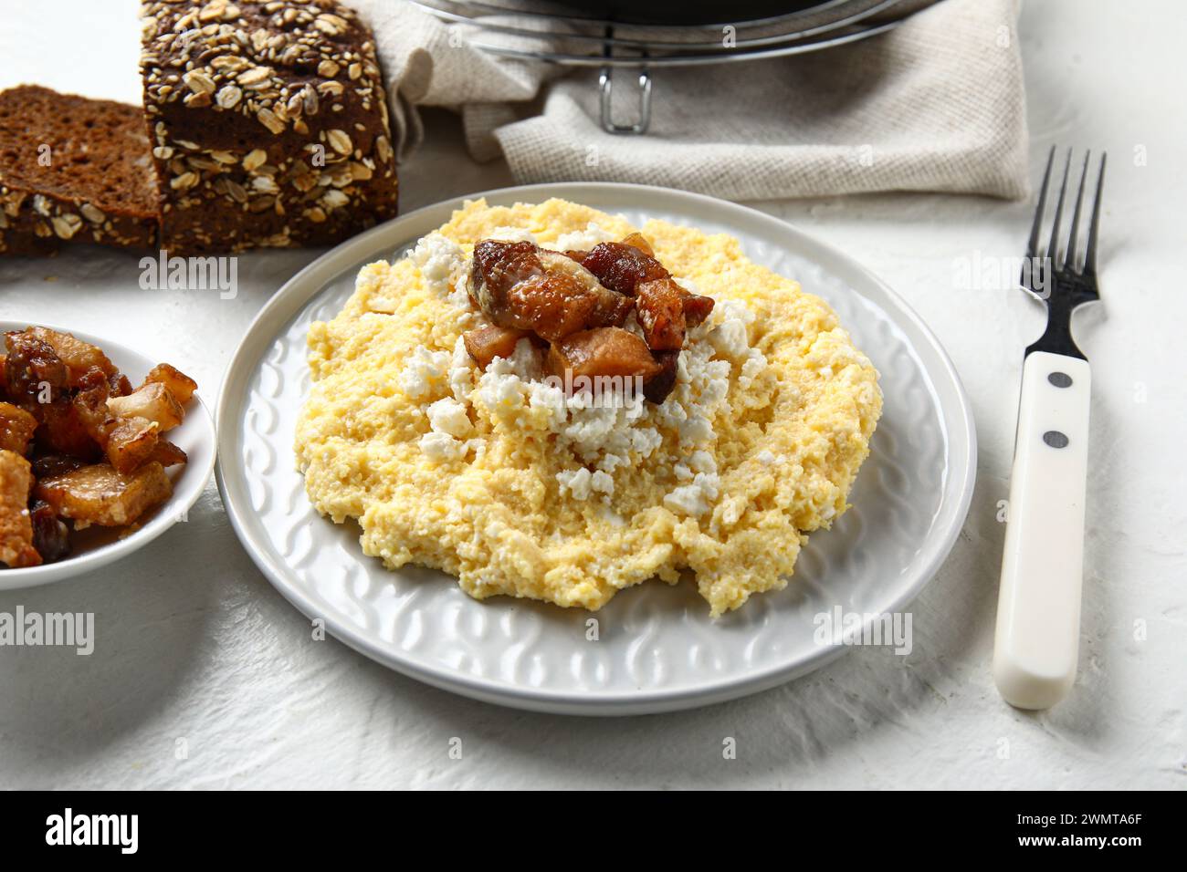 Plate of tasty banosh on white background Stock Photo - Alamy
