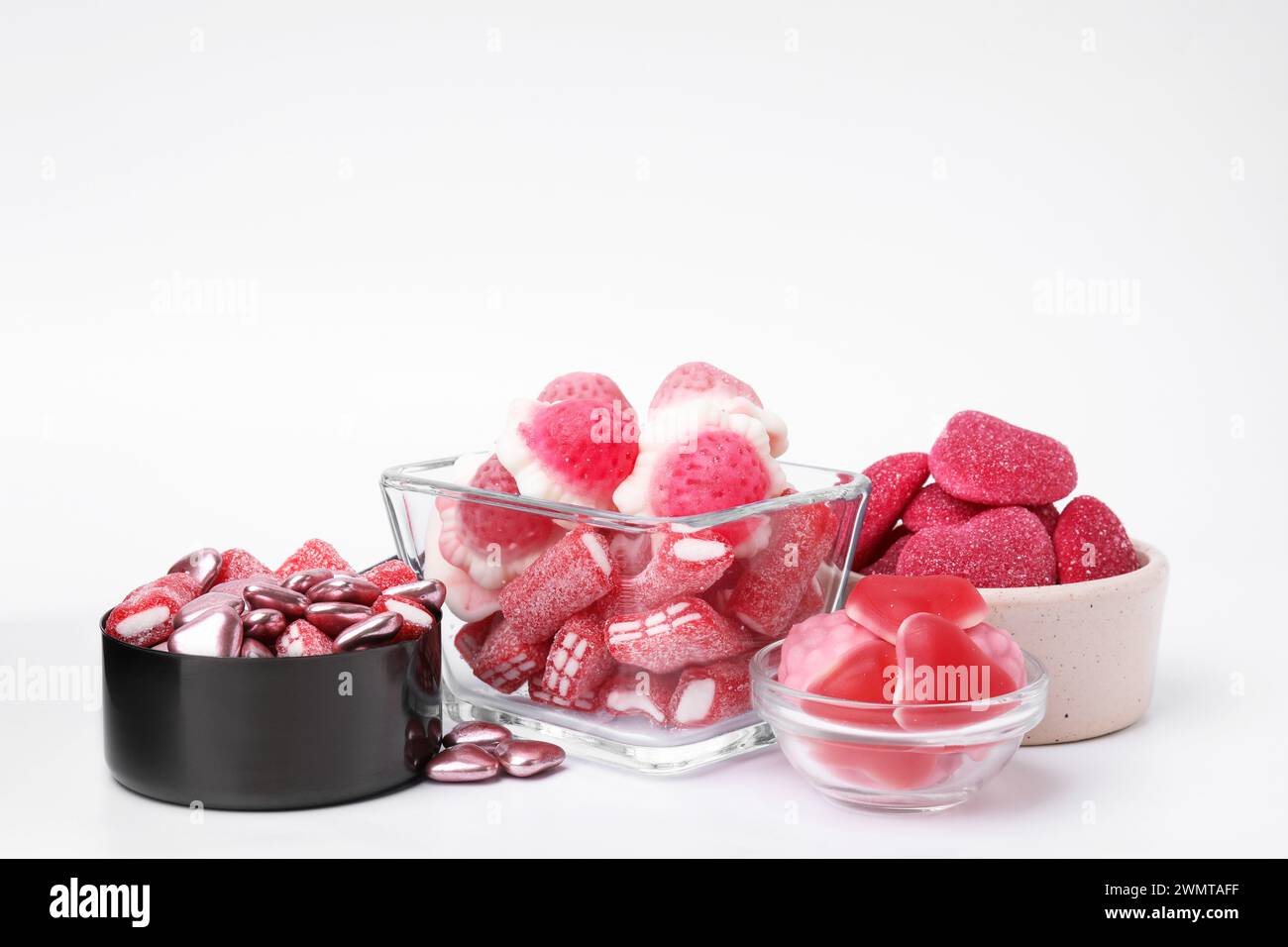 Different yummy pink candies on white background Stock Photo - Alamy
