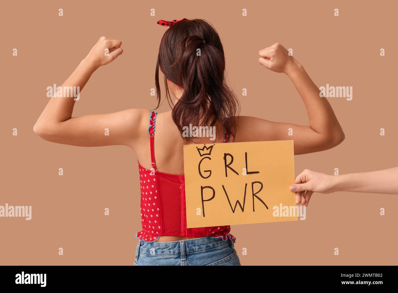 Female hand holding card with text GIRL POWER and pin-up woman showing ...