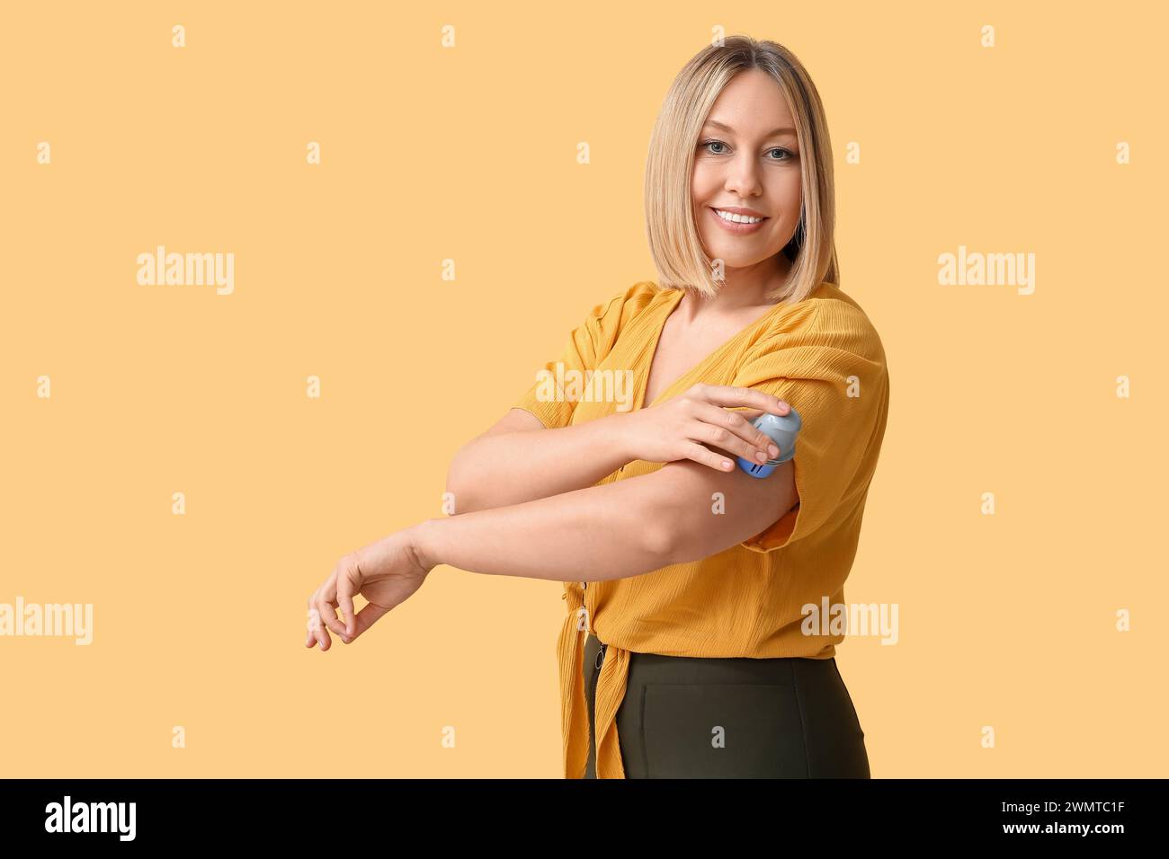 Woman with glucose sensor for measuring blood sugar level and ...