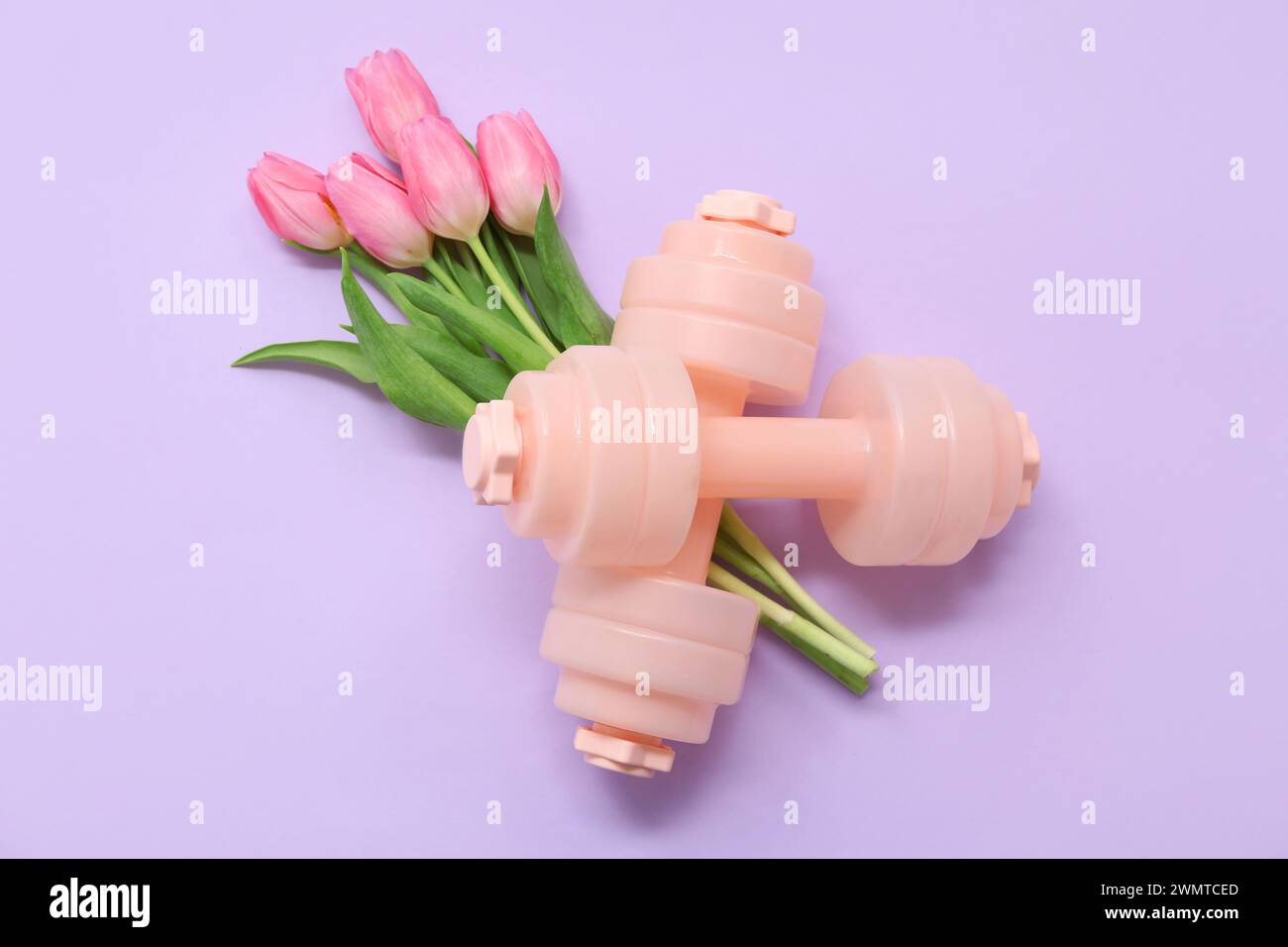 Pair of dumbbells and beautiful tulip flowers for International Women's ...