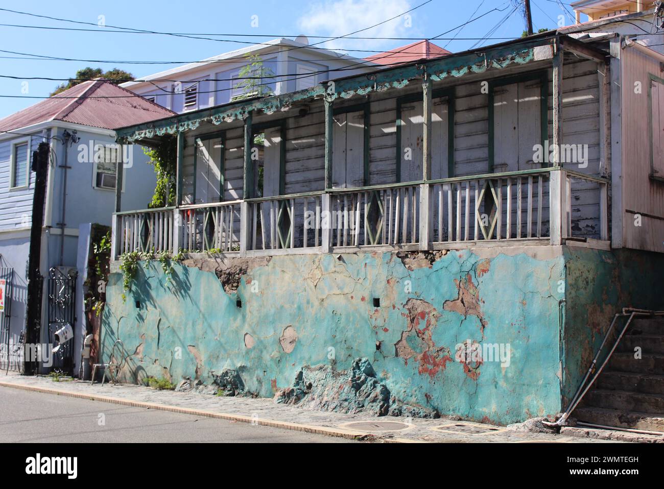 Abandoned blue stone building with blue wooded shutters in St Thomas US ...
