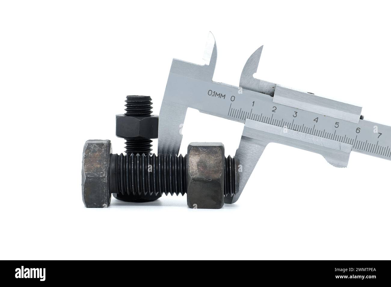 Caliper measure two adjacent black bolts with hexagonal heads, lying on ...
