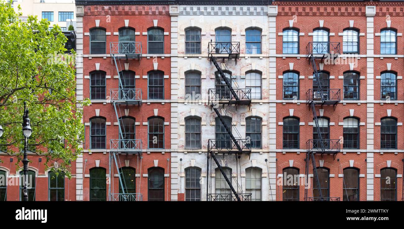 Block of historic apartment buildings with windows and fire escapes in ...