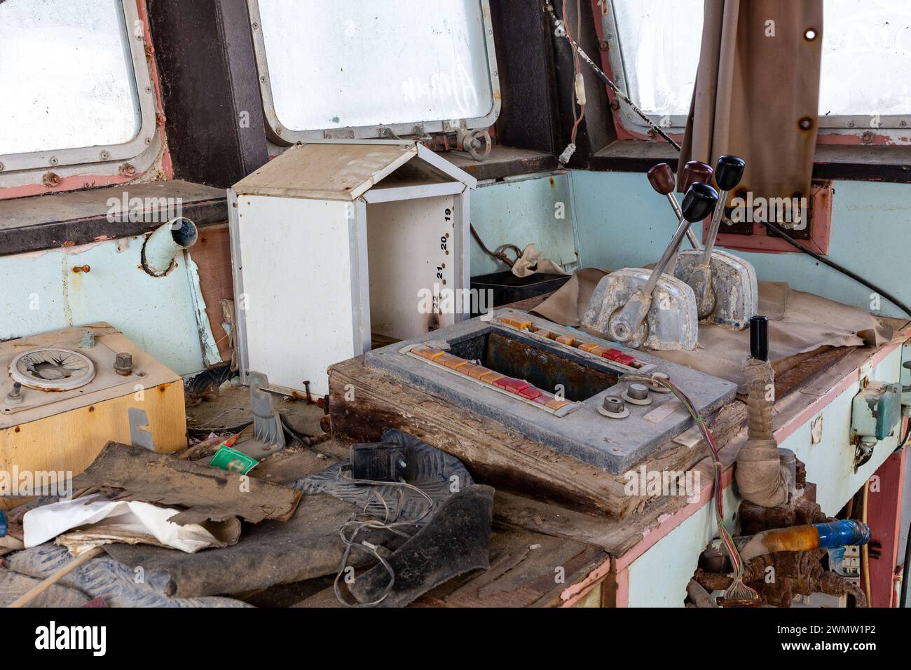 Abandoned and demolished cargo ship bridge inside view with throttle ...