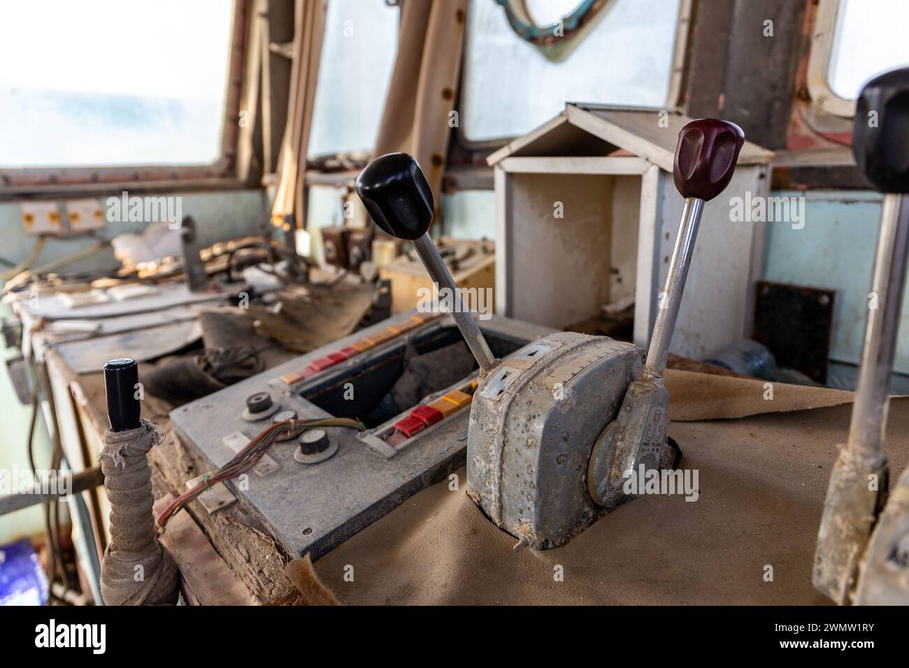 Abandoned and demolished cargo ship bridge inside view with throttle ...