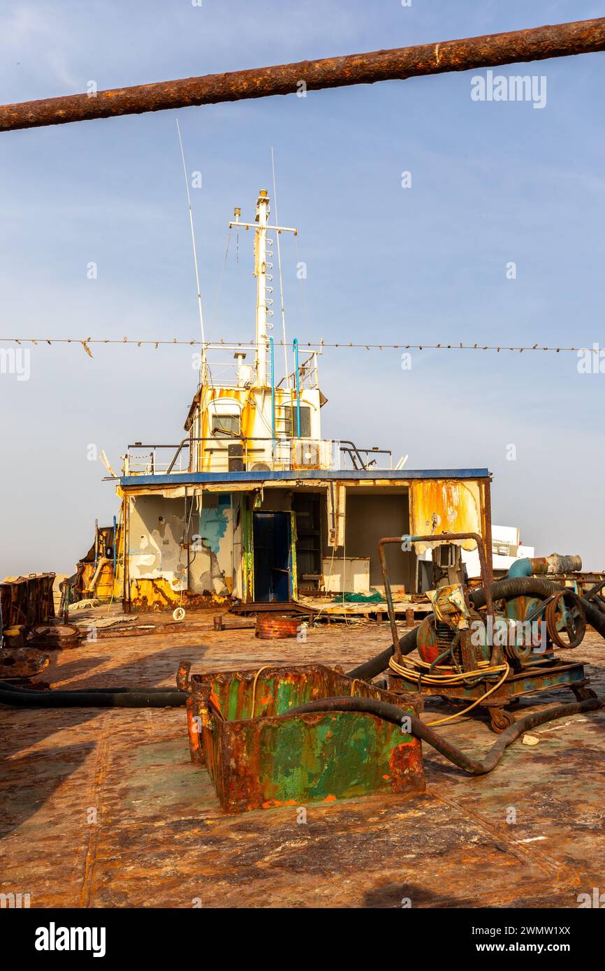 Demolished and rusty deck of a cargo ship with old bridge, mast ...