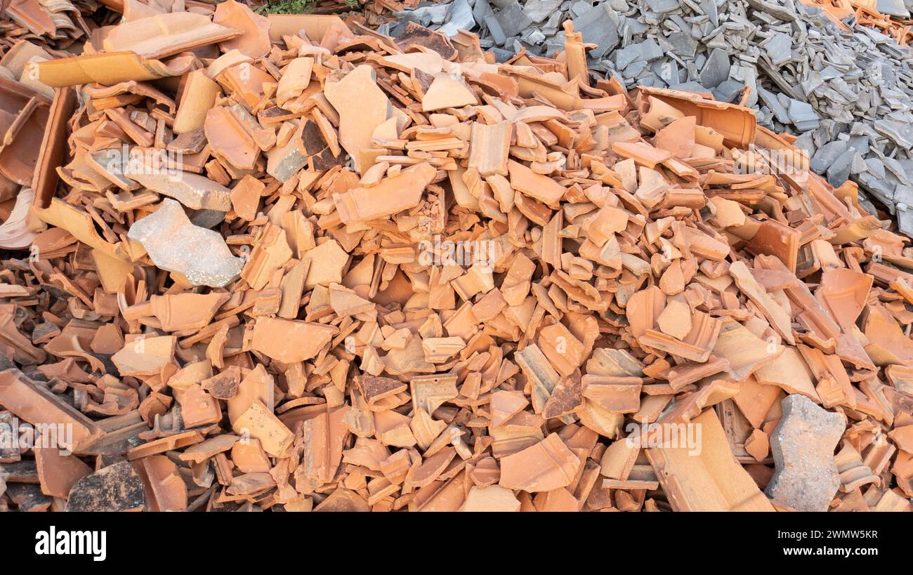 Pile of broken roof tiles after a hail storm for roof restoration of ...
