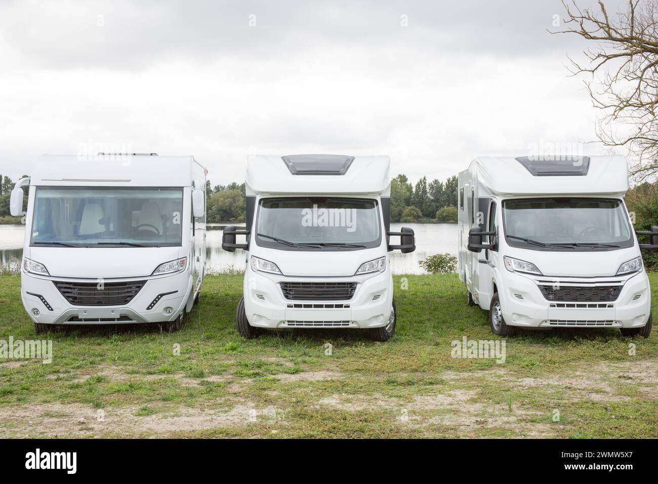 three caravan camper motorhome of face in an exhibition or a garage of ...