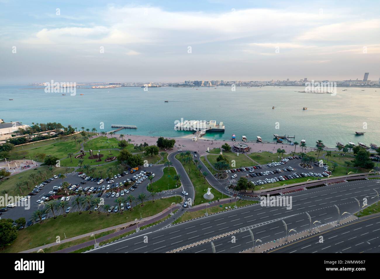 Aerial view of Doha Corniche sunset sunrise. Corniche road and traffic ...
