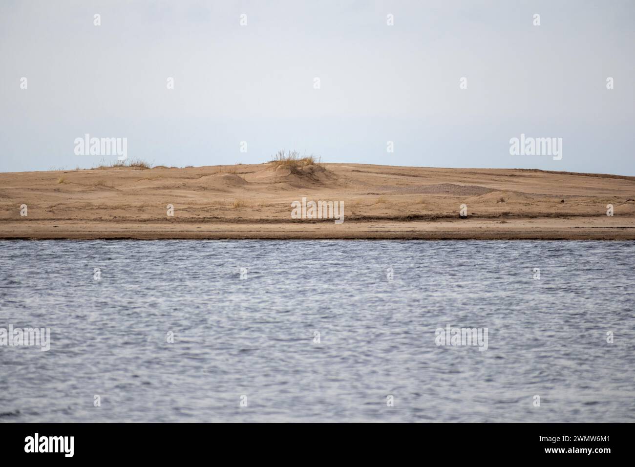 Horizontal lines with blue water brown sand and gray sky edge Stock ...
