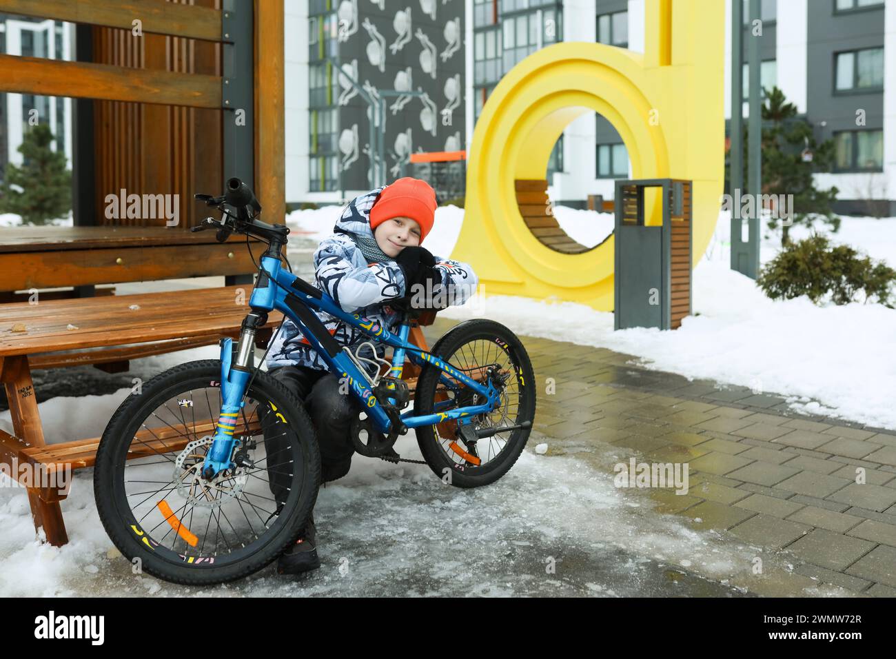 Cute boy got tired while riding a bike and sat down to rest Stock Photo ...