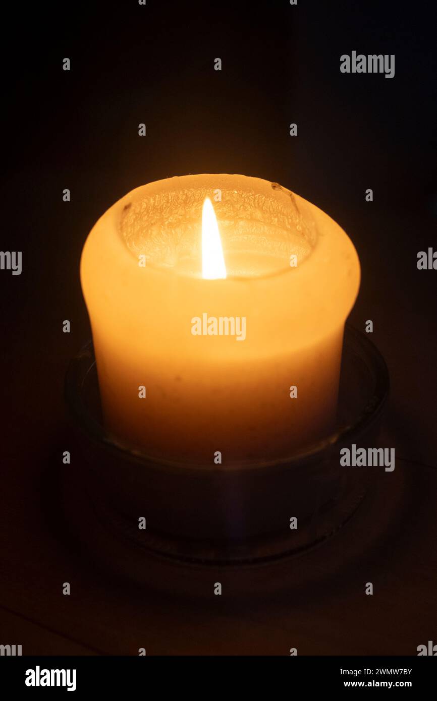 A candle in the dark Stock Photo - Alamy
