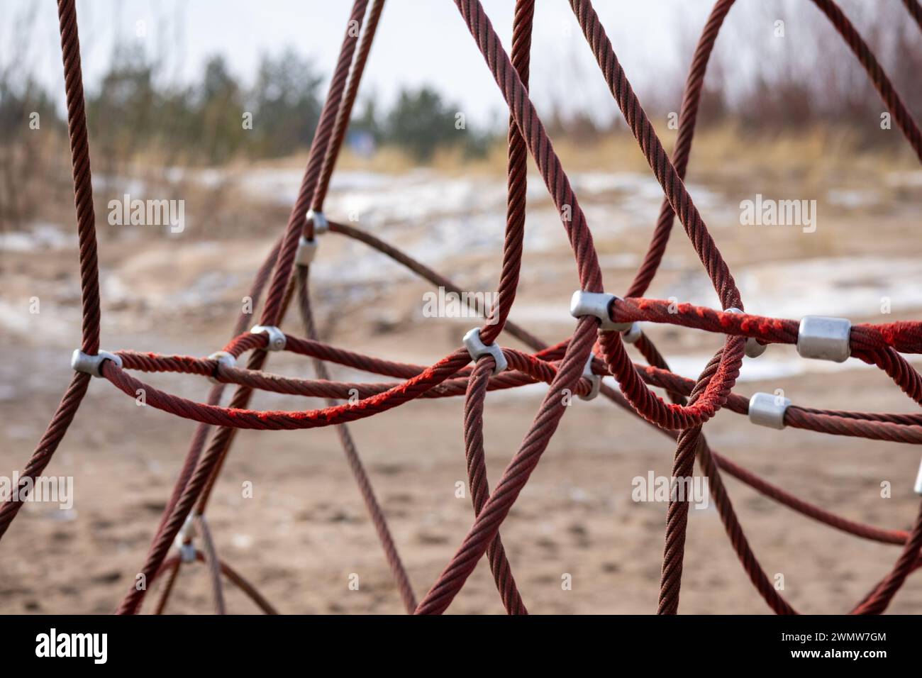 Red rope sections fastened with a metal clamp and a brown sand ...