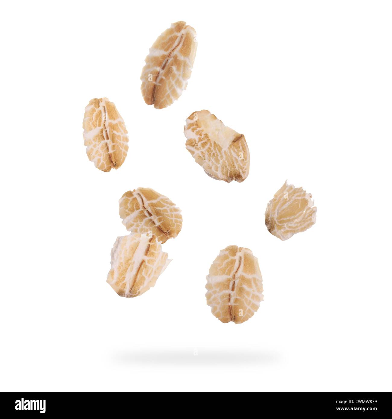 Rolled oat flakes falling on white background Stock Photo - Alamy