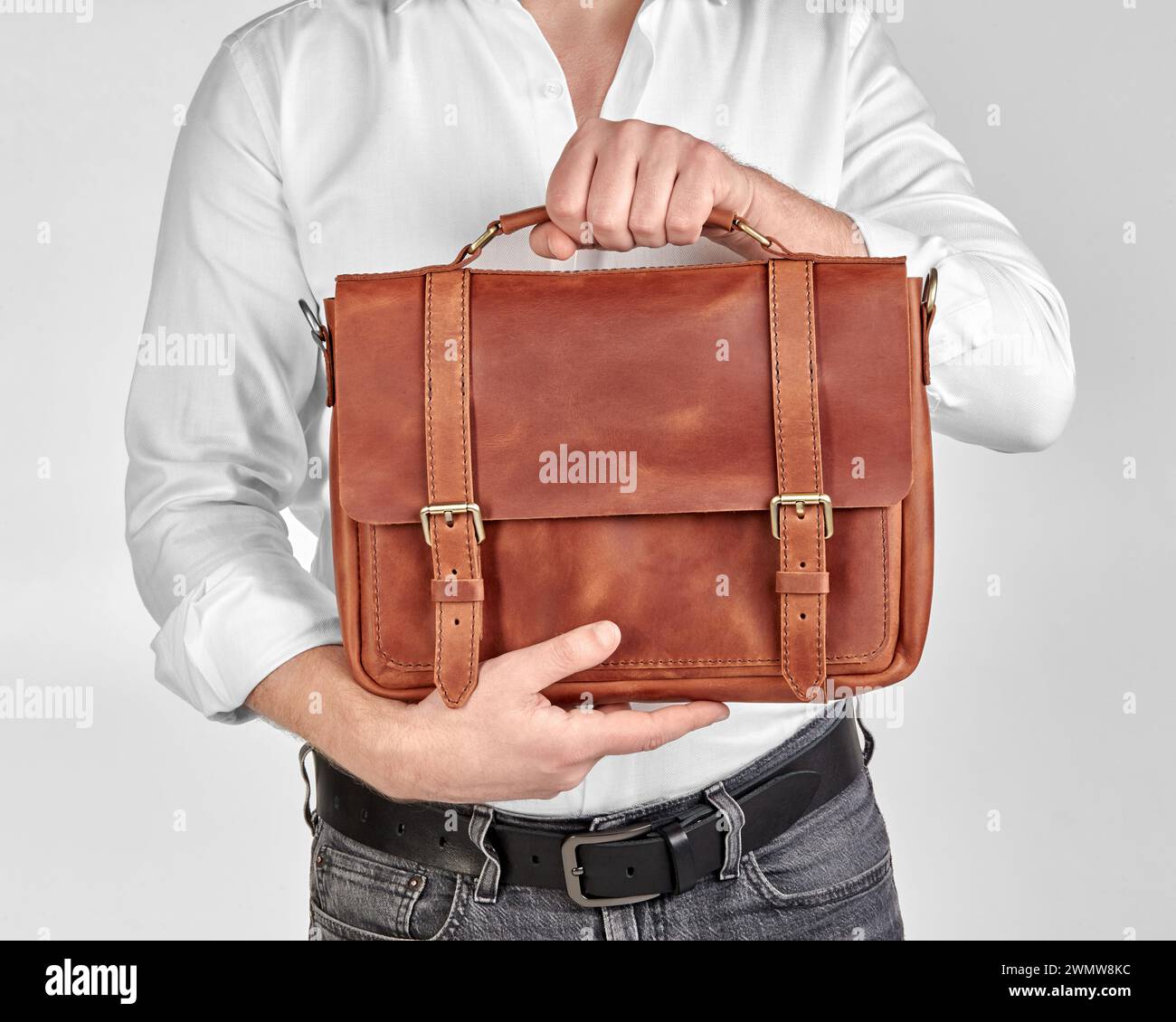 Custom brown leather briefcase with embossed initials in male hands ...