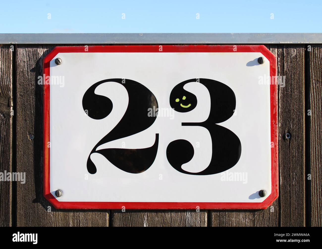 collage, number 23 metal sign, a wooden wall with smiley, blue sky ...
