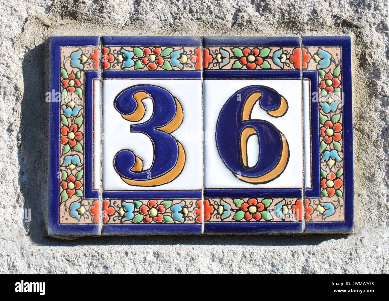 collage, house number ceramic sign of enamel or clay on a stone wall ...