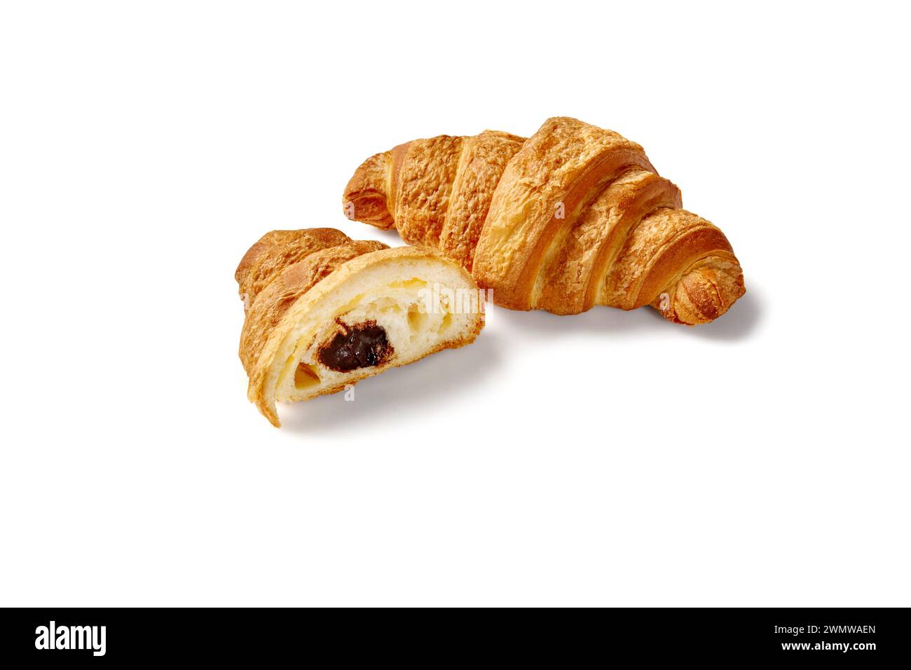 Whole and sliced gourmet fluffy croissants with rich chocolate cream ...