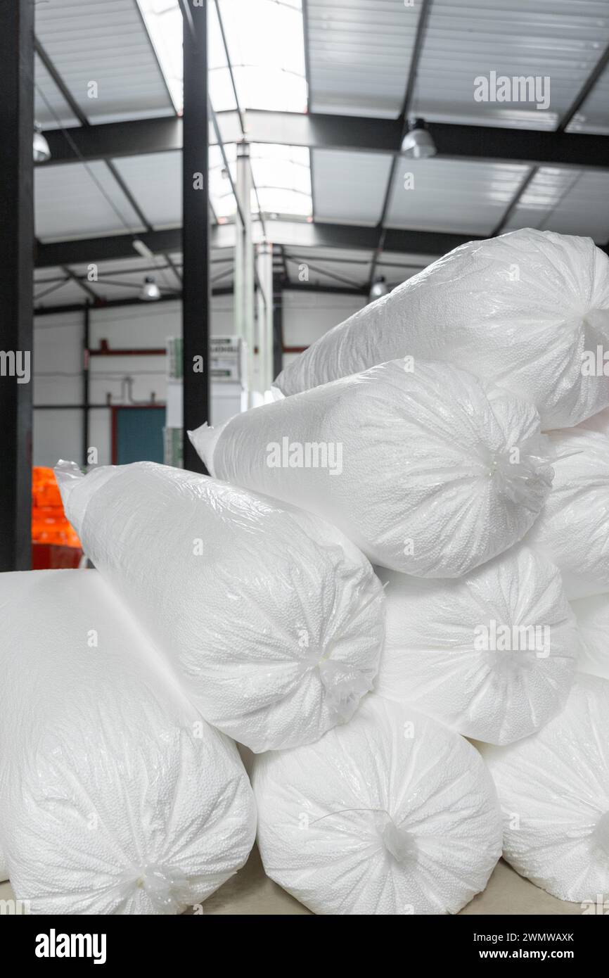 A bunch of bags of loose granular foam in a commercial warehouse. Loose ...